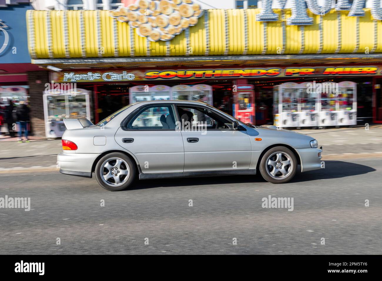 Subaru Impreza car driving past amusement arcades in Marine Parade ...
