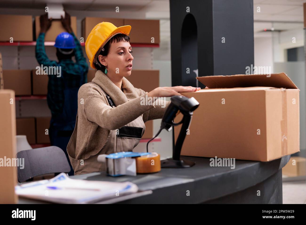 Retail storehouse manager packing cardboard box at counter desk and ...