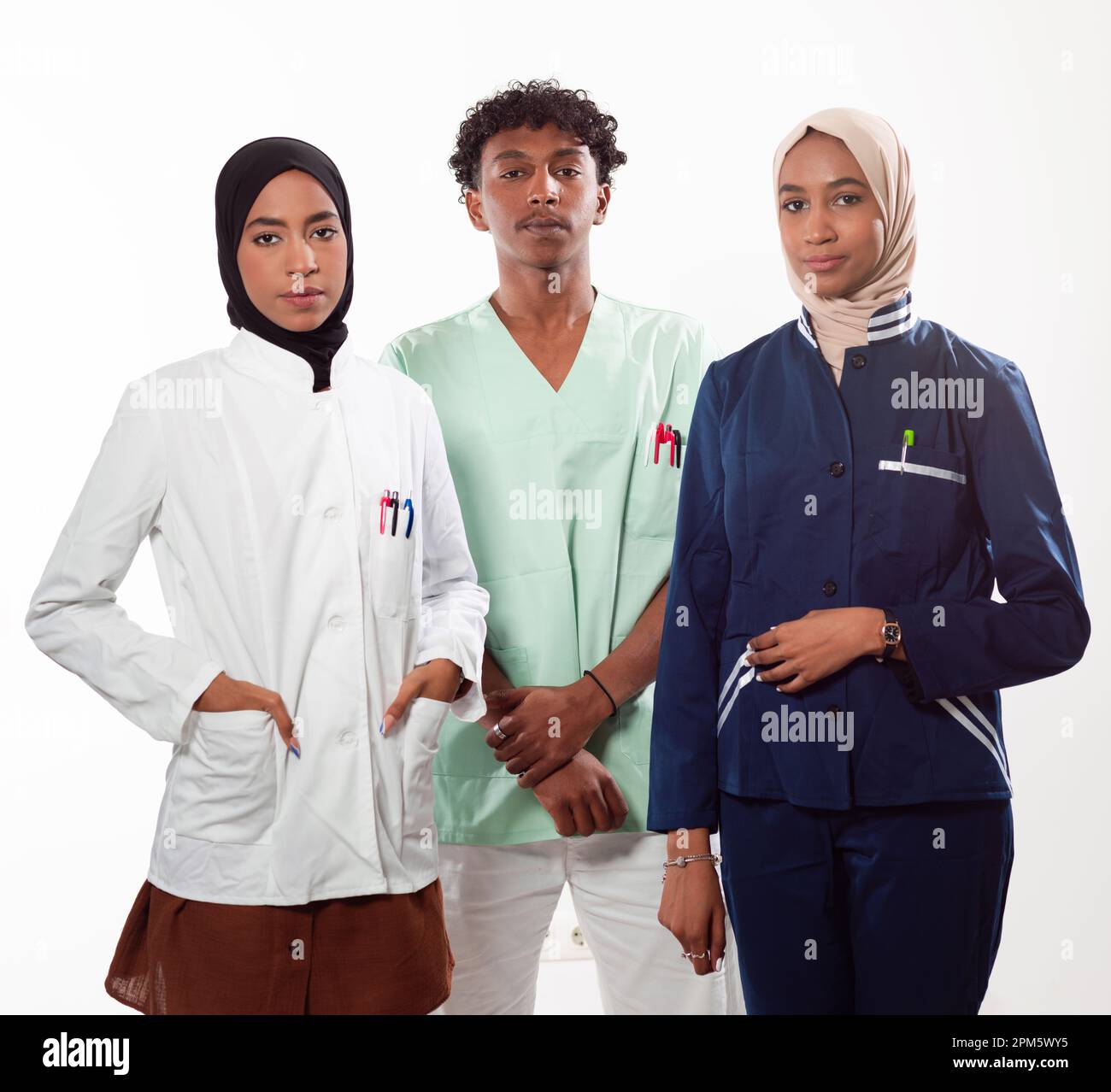 Closeup front view of group of mixed age doctors and nurses standing side by side and looking at ...