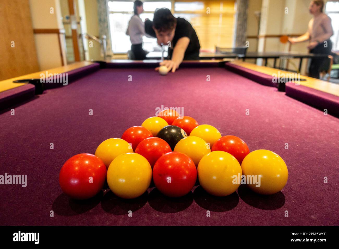 A boy aiming to break off a game of pool Stock Photo - Alamy