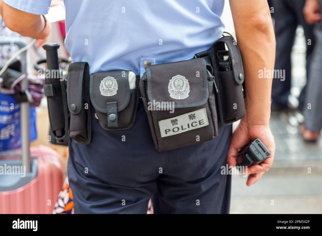 Close-up on the belt of a Chinese police officer in Beijing displaying ...