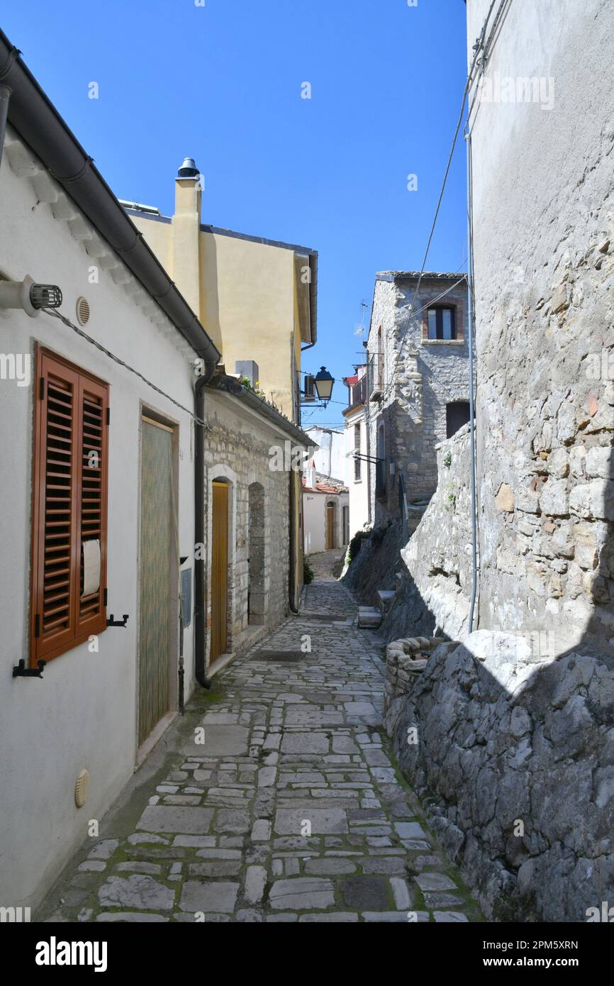 A narrow street among the old houses of Guardialfiera, a historic town ...