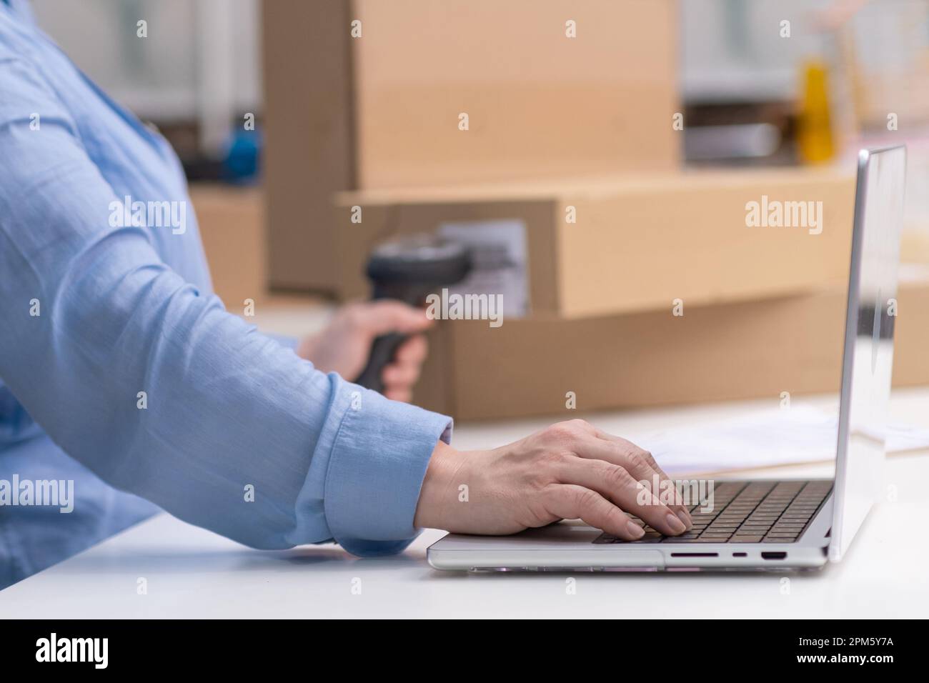 Checking product barcodes before delivery SME business, closeup laptop ...