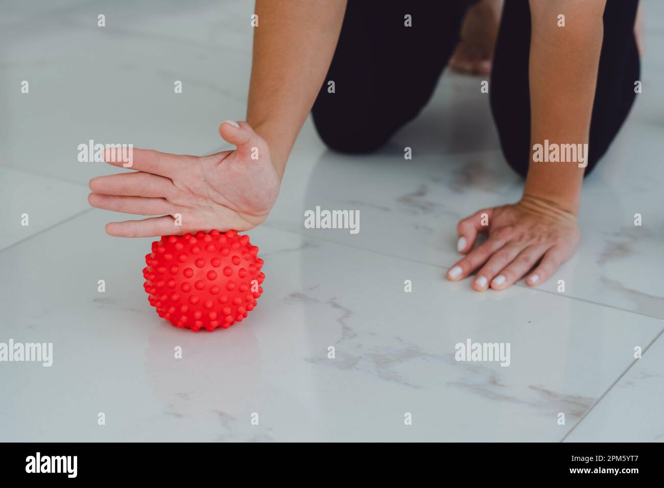 Woman hands pressing on small ball to relieve pain in arms massage ...