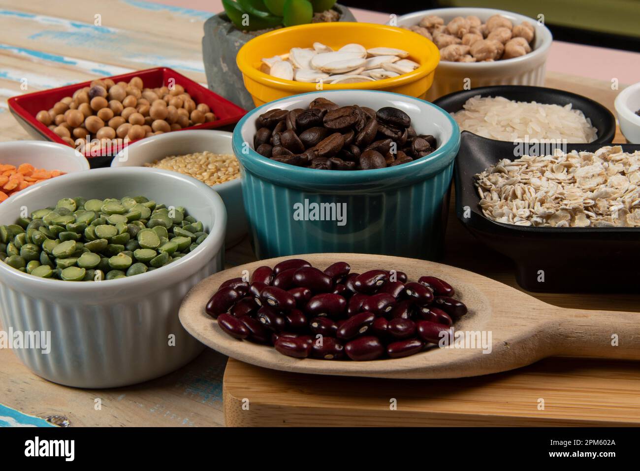 Different types of legumes in bowls, green and yellow peas, chickpeas ...