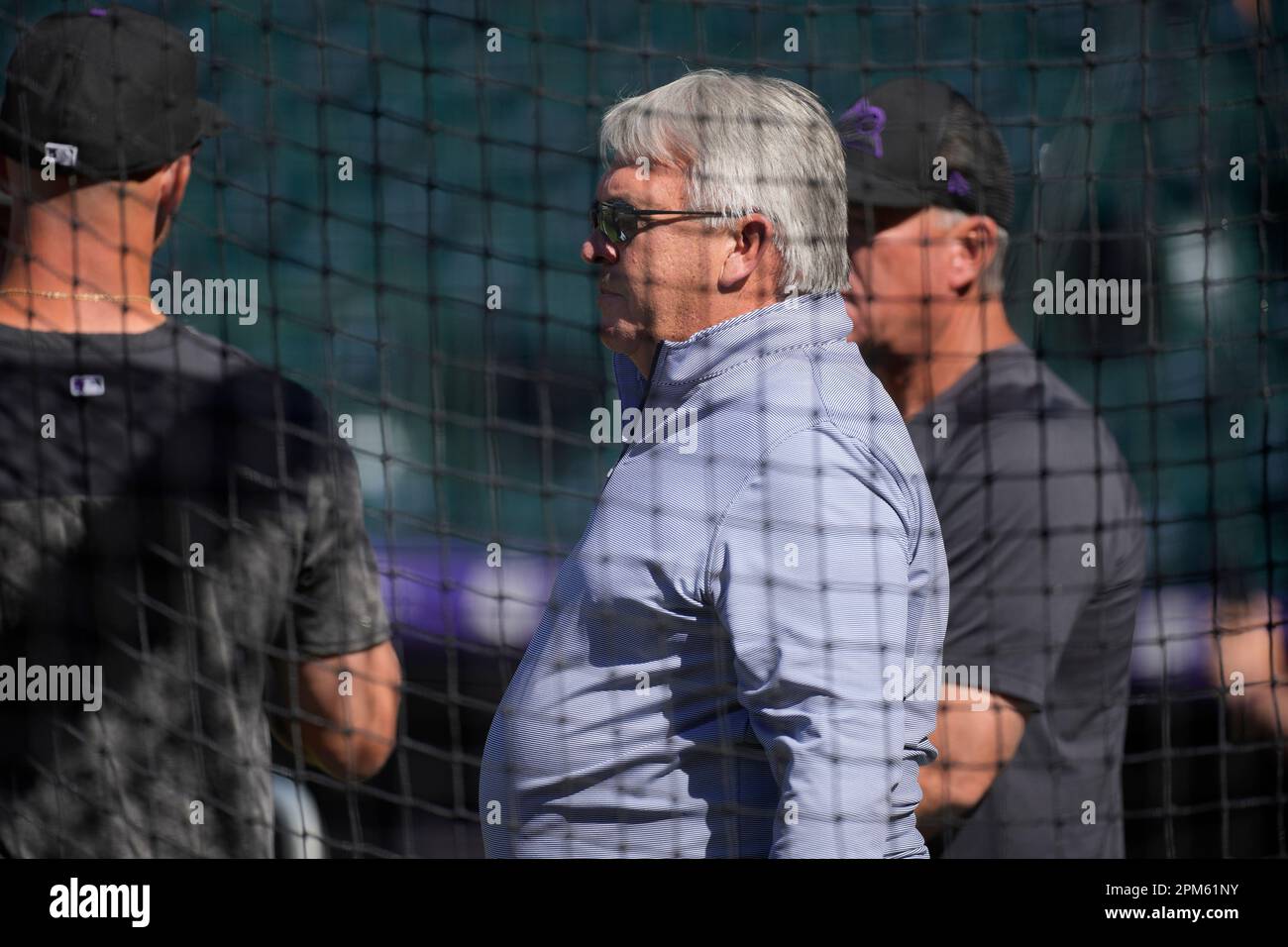 Colorado Rockies general manager Bill Schmidt looks on as players warm ...