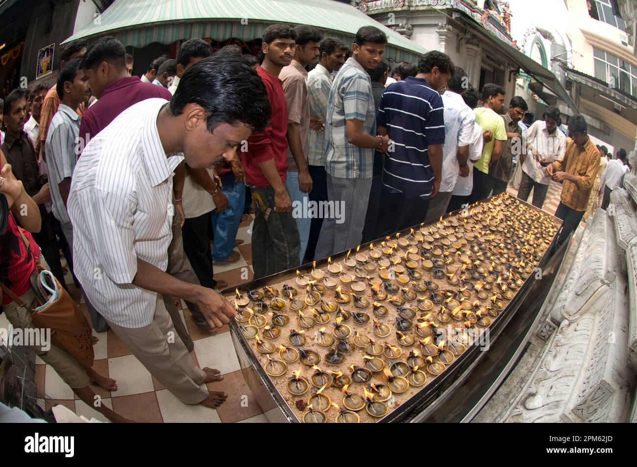 Devotees lighting candles furing Deepavali ceremony, Sri ...