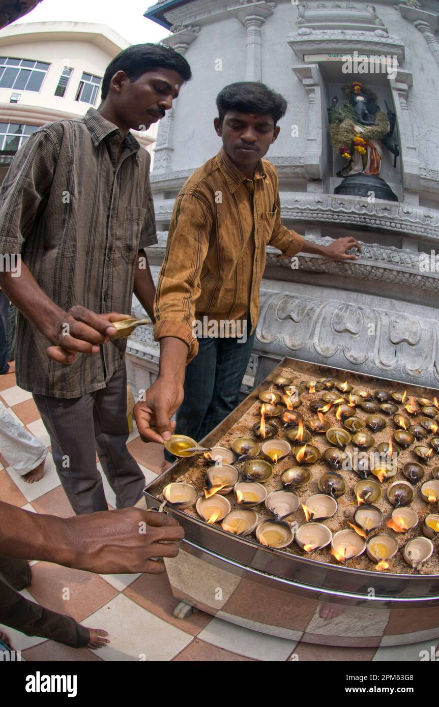 Devotees lighting candles furing Deepavali ceremony, Sri ...