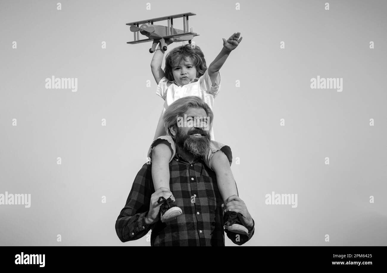 Fathers day. Father and son. Father giving son ride on back. Portrait ...