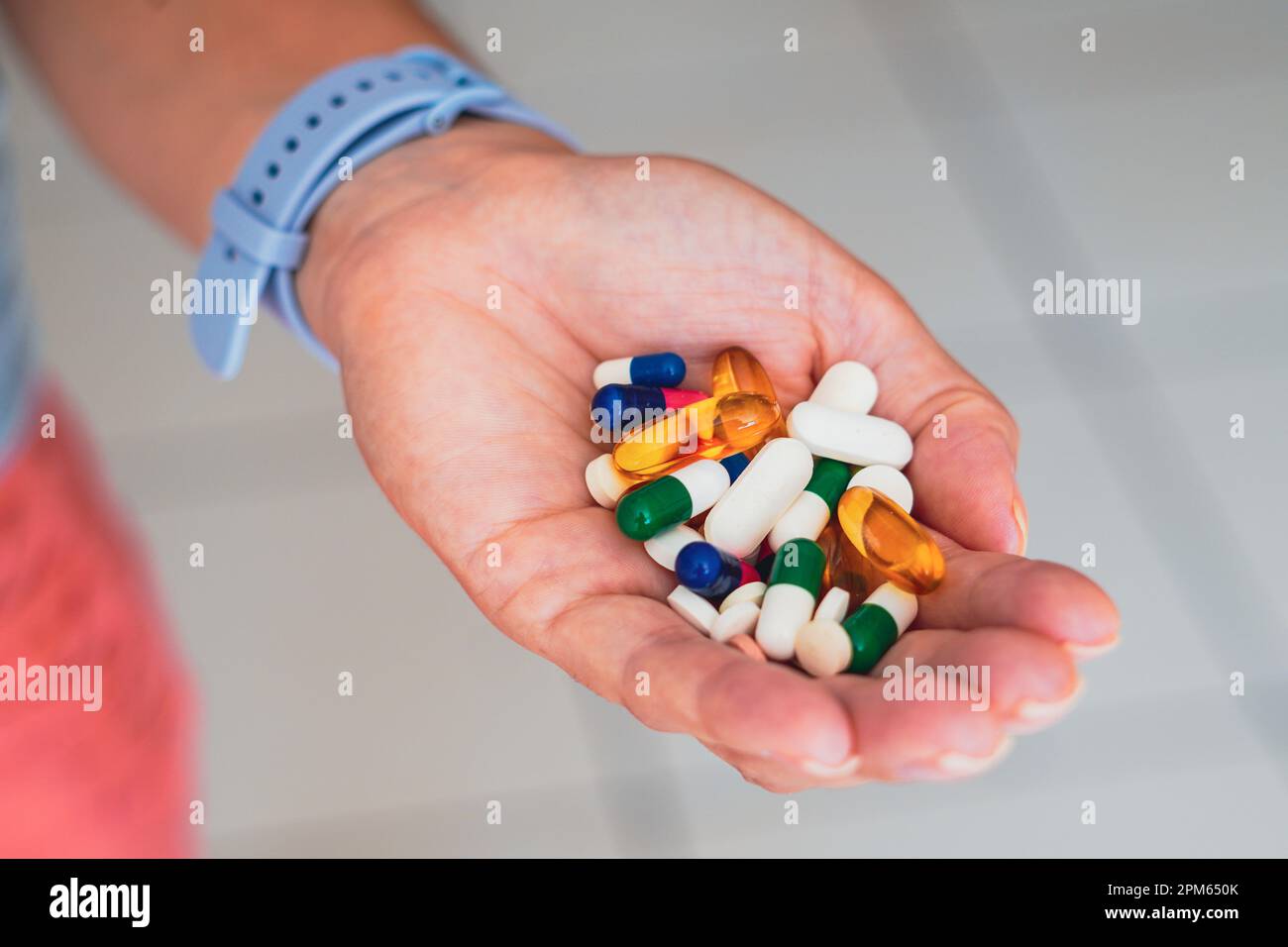 A person holds several medicine pills in his hand Stock Photo - Alamy