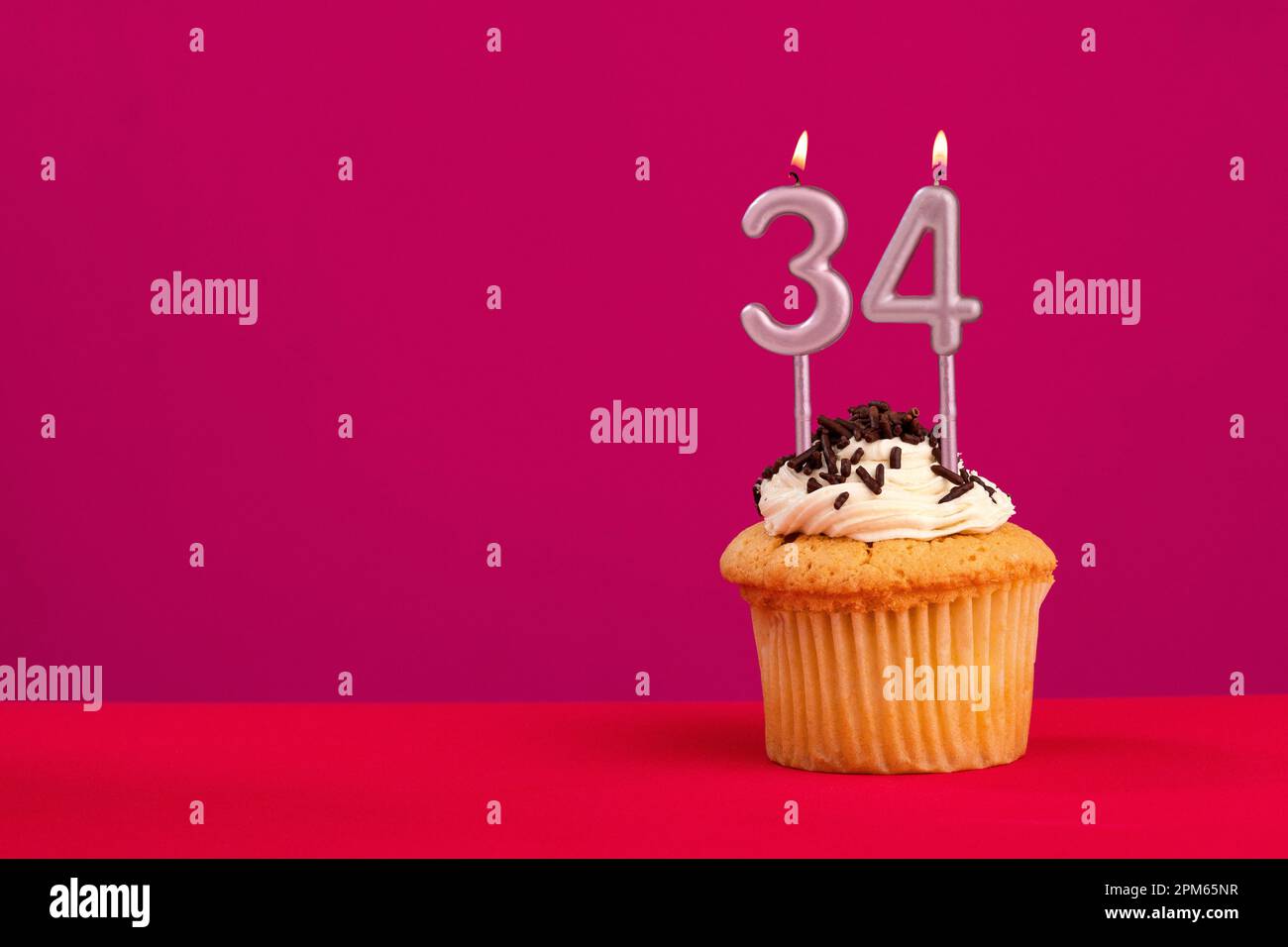 Candle number 34 - Cake birthday in rhodamine red background Stock ...