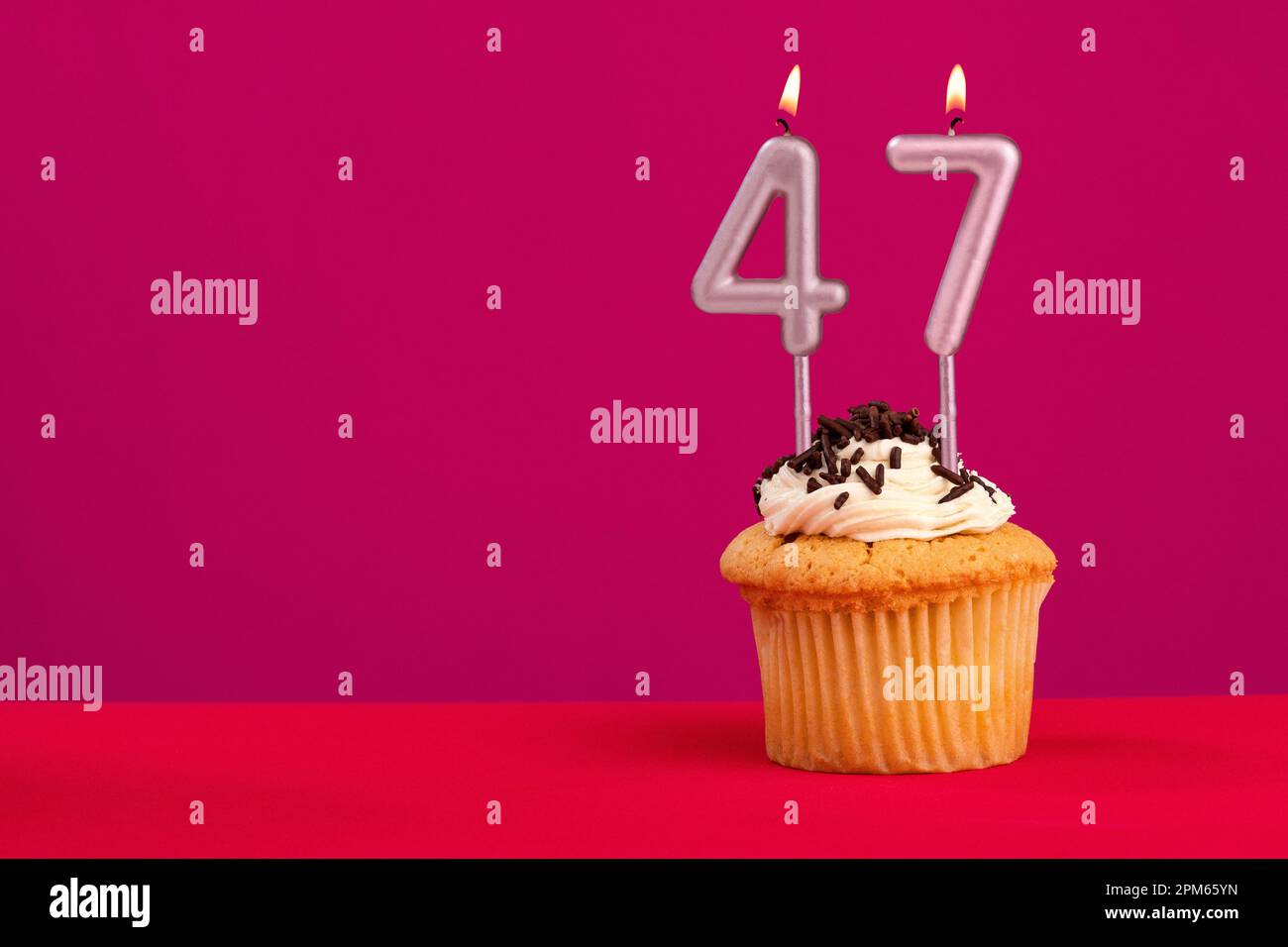 Birthday cake with candle number 47 - Rhodamine Red foamy background ...