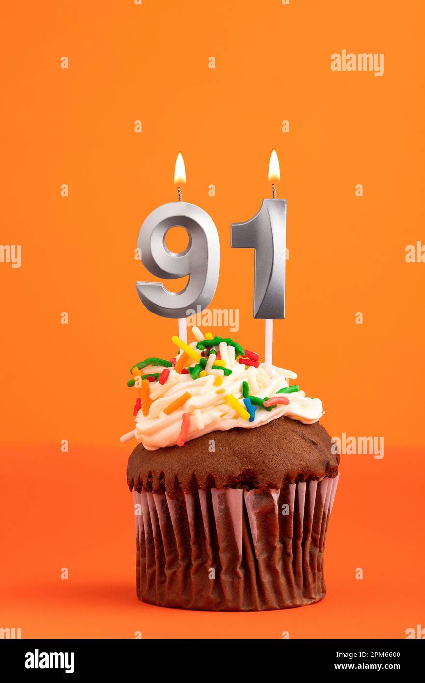 Candle number 91 - Cake birthday in orange background Stock Photo - Alamy