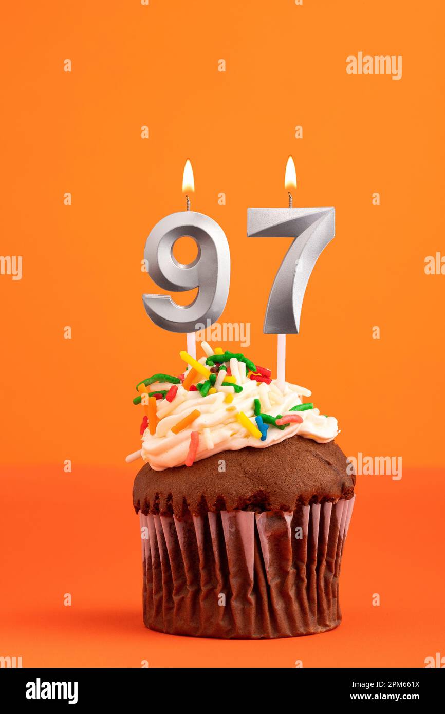 Candle number 97 - Cake birthday in orange background Stock Photo - Alamy
