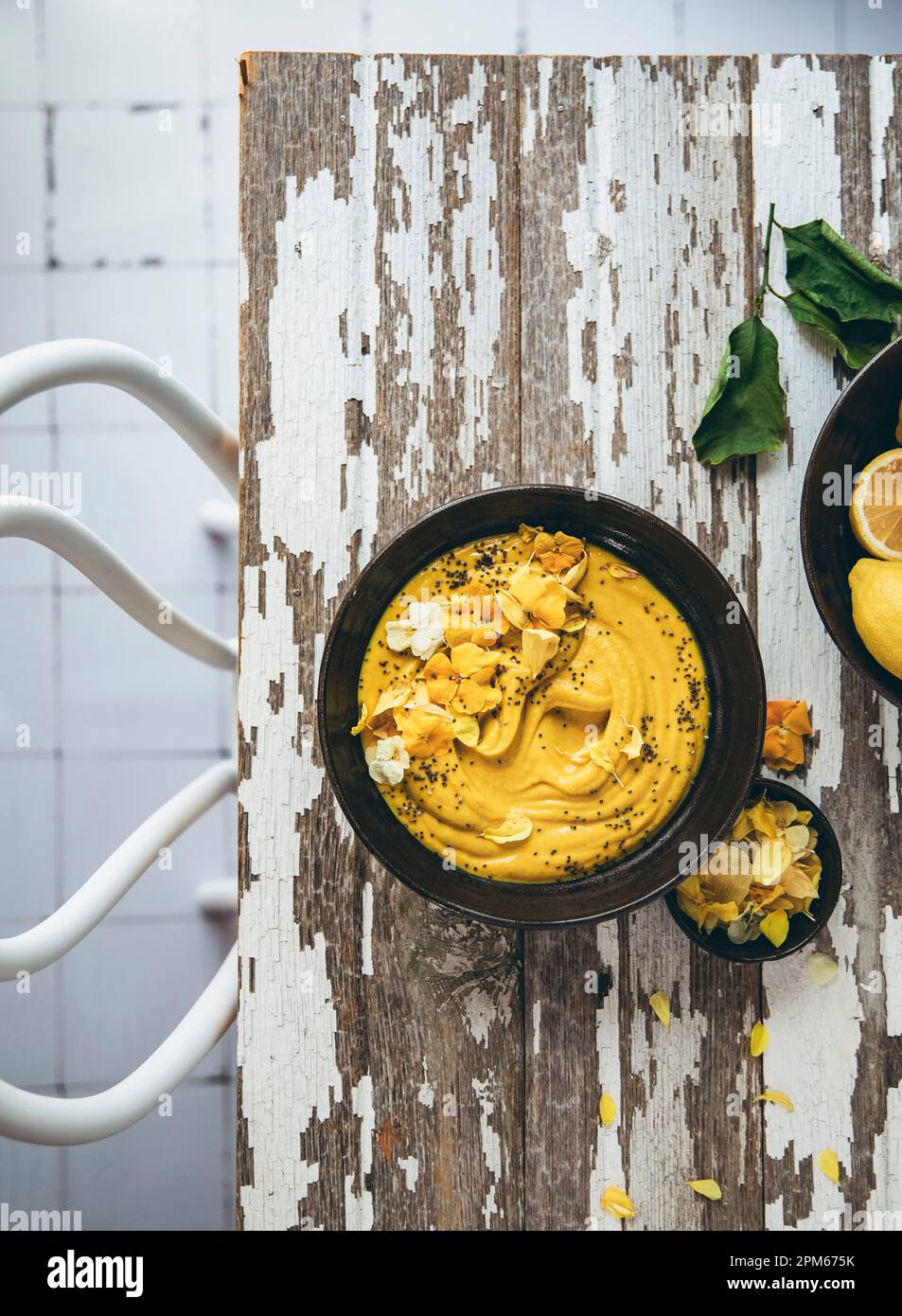 A lemon dessert smoothie bowl with edible flowers Stock Photo - Alamy