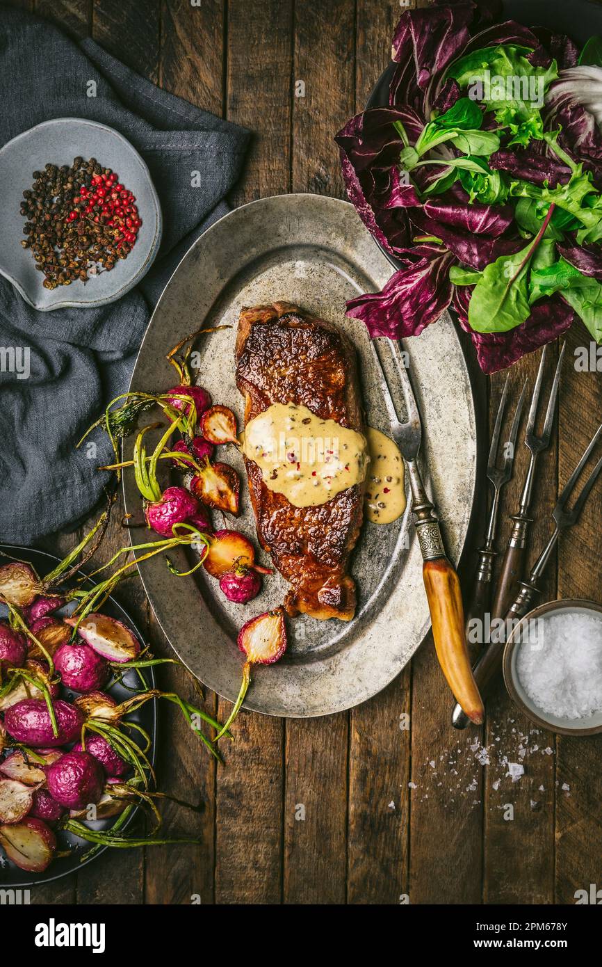 Steak au poivre with Cream Sauce and Roasted Radishes on Metal Plate ...