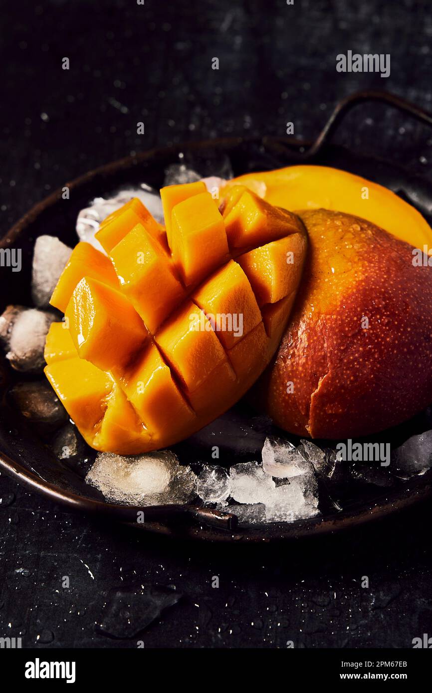 Fresh Mango on black tray and black background Stock Photo - Alamy