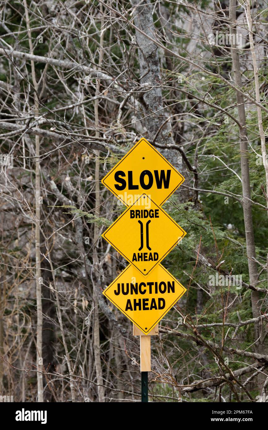 Bright yellow signs on a snowmobile trail in the Adirondack Mountains ...