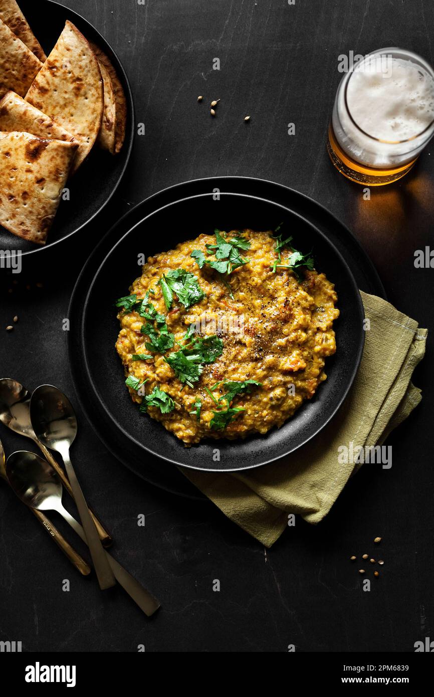 Overhead View of Indian Tarka Dal Curry with Roti, Beer and Cilantro ...