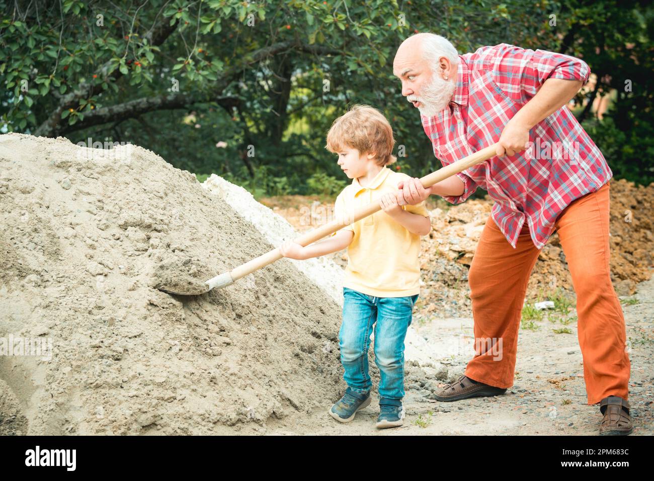 Little son helping his father with building work. Childhood concept ...
