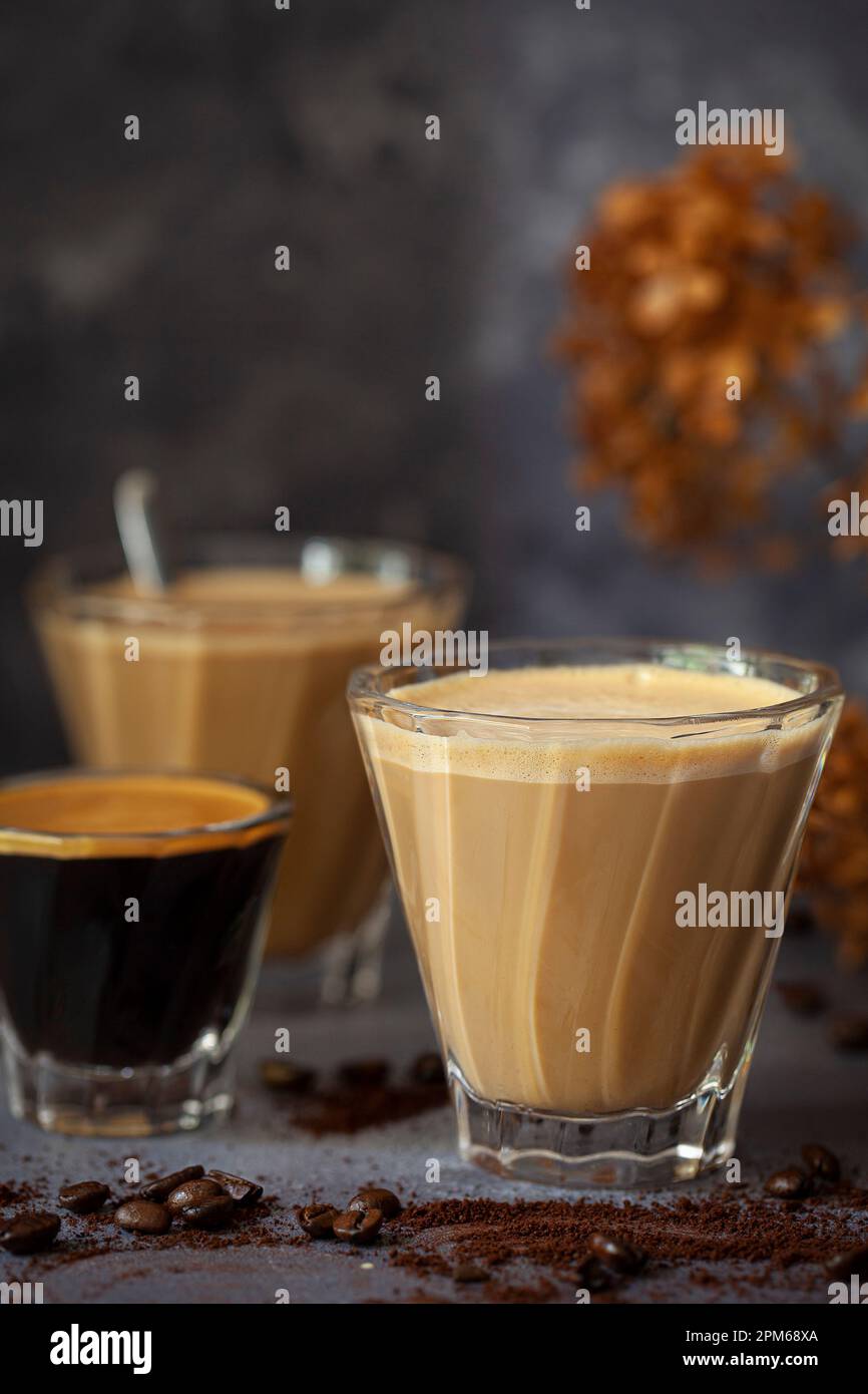 Glasses of Spanish Latte (caffe con leche) with a shot of espresso in a ...