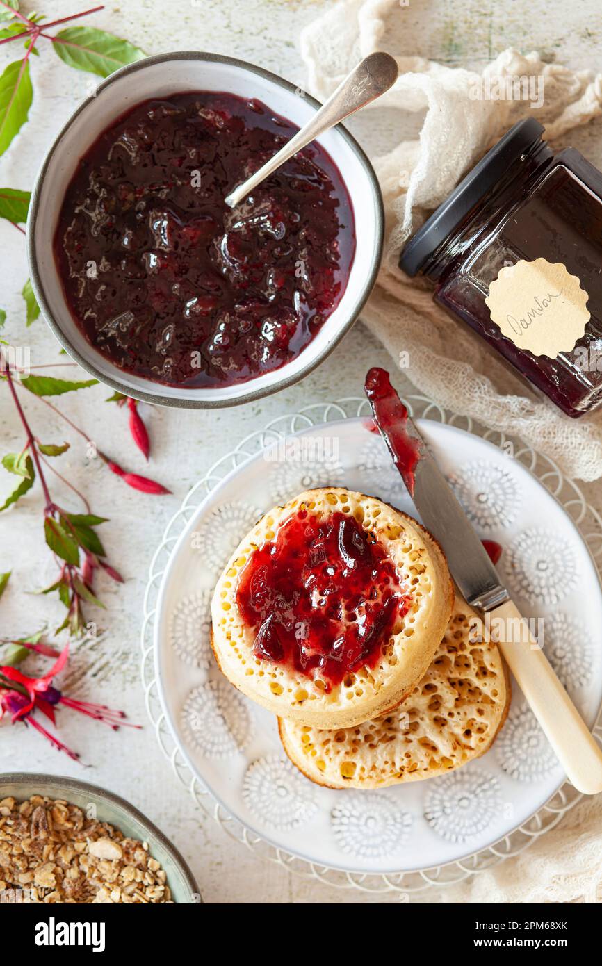 A bowl of damson jam, a jar of homemade jam and jam spread on toasted ...
