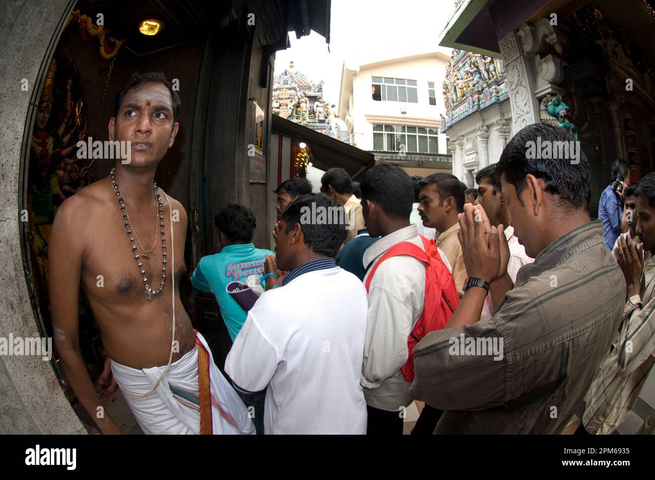 Priest with devotees during Deepavali ceremony, Sri Veeramakaliamman ...