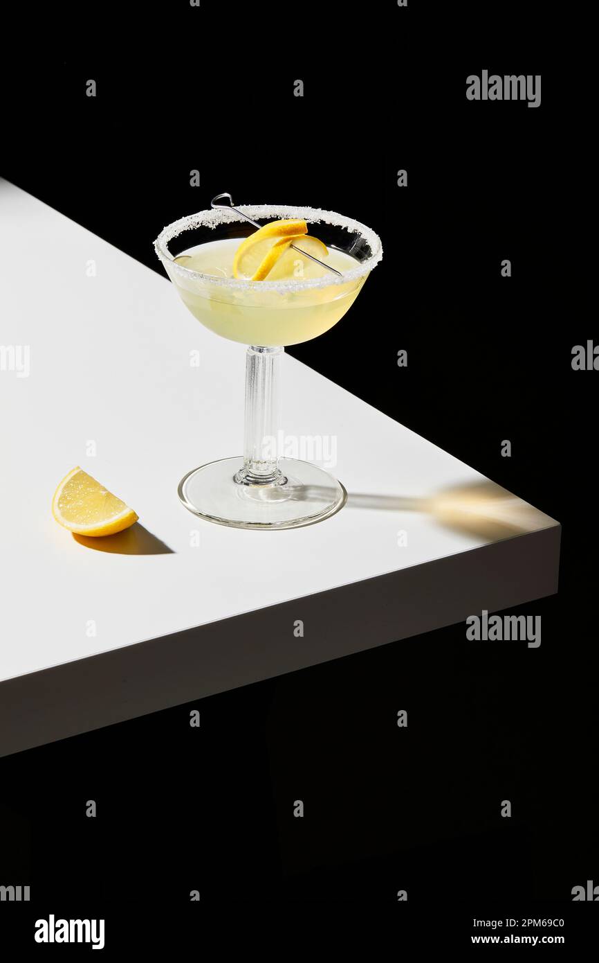Lemon Cocktail on a White Table and Black Background Stock Photo - Alamy