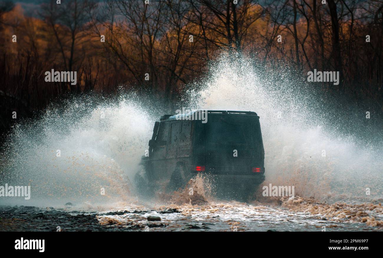 Off road. Suv splash on the river outdoor, traveling on the road. cene ...