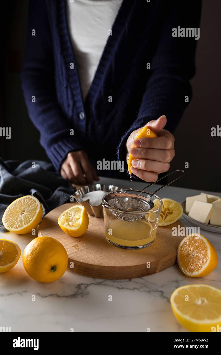 Squeezing Lemons for Lemon Curd Stock Photo - Alamy