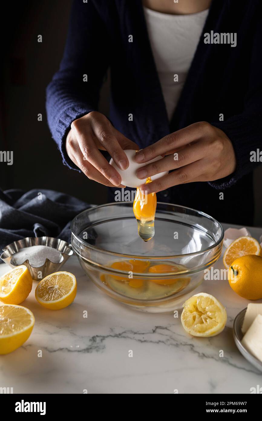 Cracking Eggs for Lemon Curd Stock Photo - Alamy