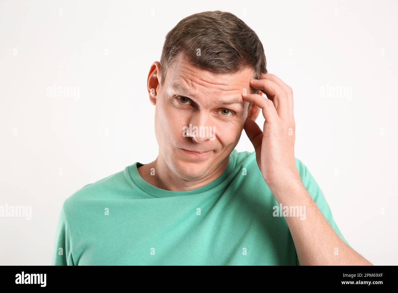 Emotional man in casual outfit on white background Stock Photo - Alamy