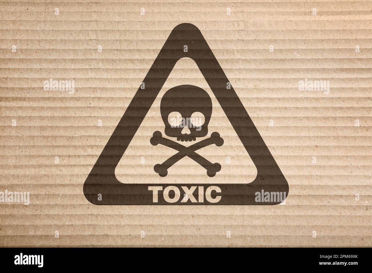 Hazard warning sign (skull-and-crossbones symbol and word TOXIC) on ...