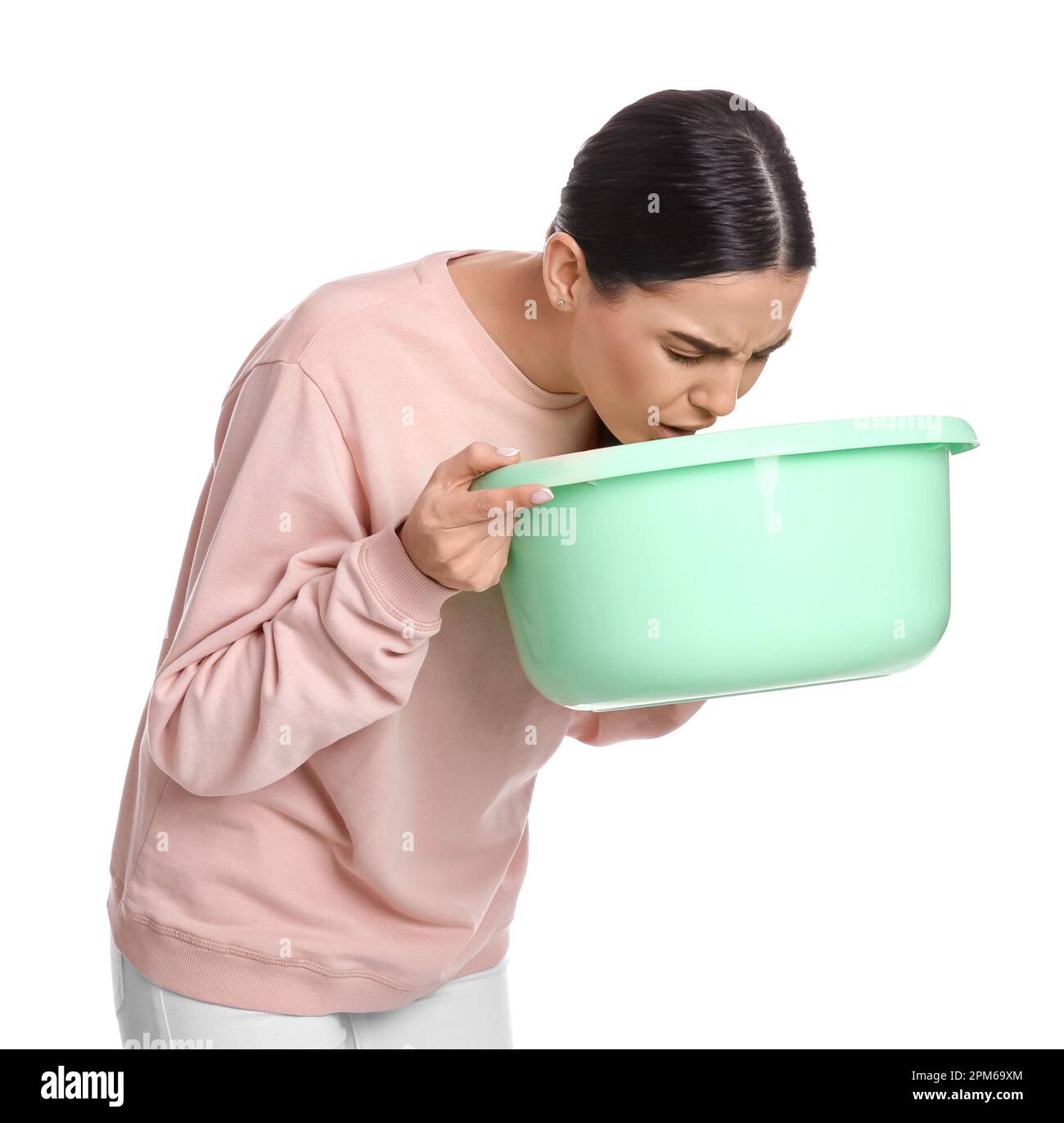 Woman with basin suffering from nausea on white background. Food ...