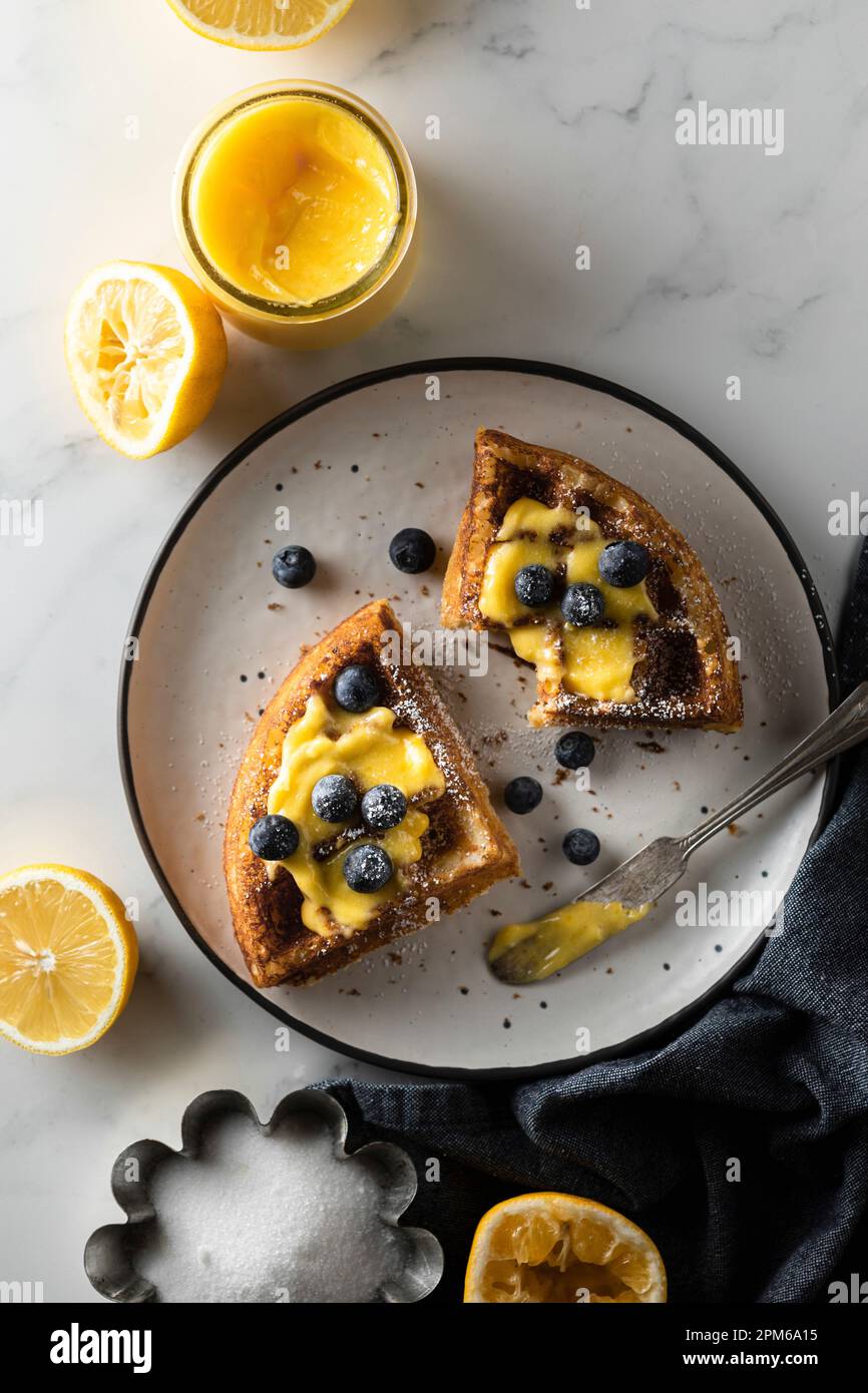 Waffles with Lemon Curd and Blueberries Stock Photo - Alamy