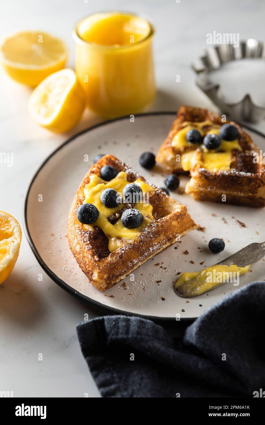 Waffles with Lemon Curd and Blueberries Stock Photo - Alamy