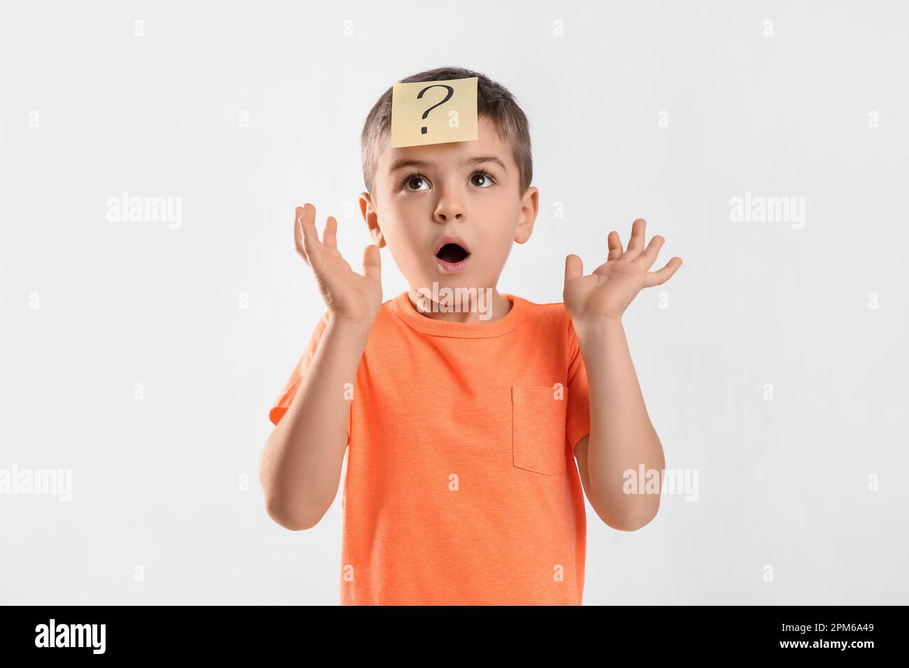 Emotional little boy with question mark on white background Stock Photo ...