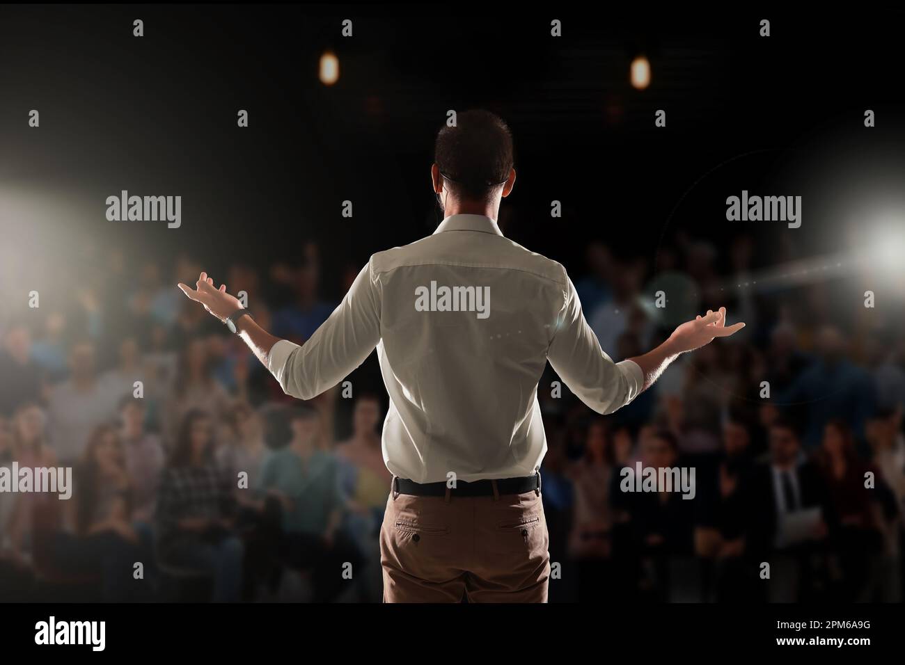 Motivational speaker with headset performing on stage, back view Stock ...