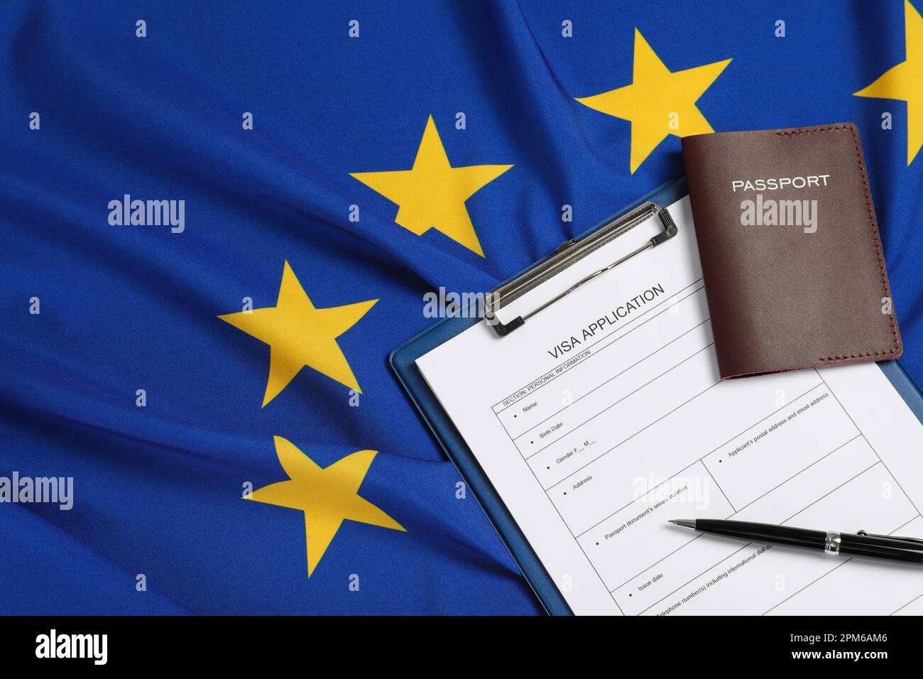 Visa application form, passport and pen on flag of European Union, flat ...