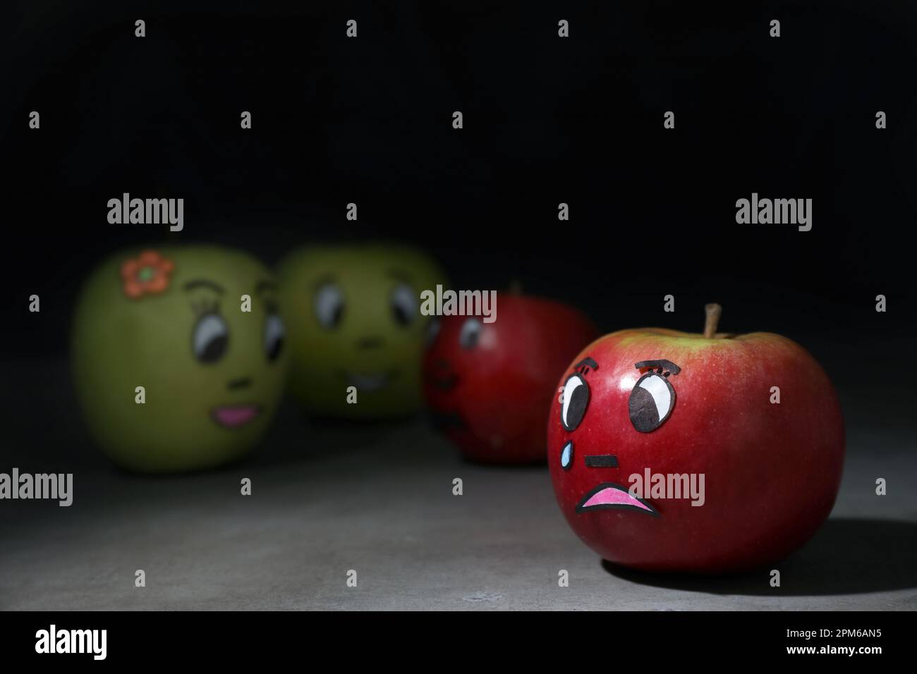 Apple with crying face on grey table. Concept of jealousy Stock Photo ...