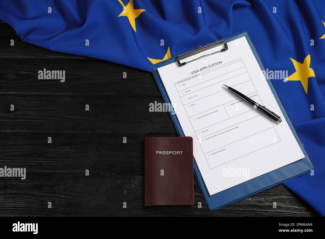 Visa application form, passport, pen and flag of European Union on ...