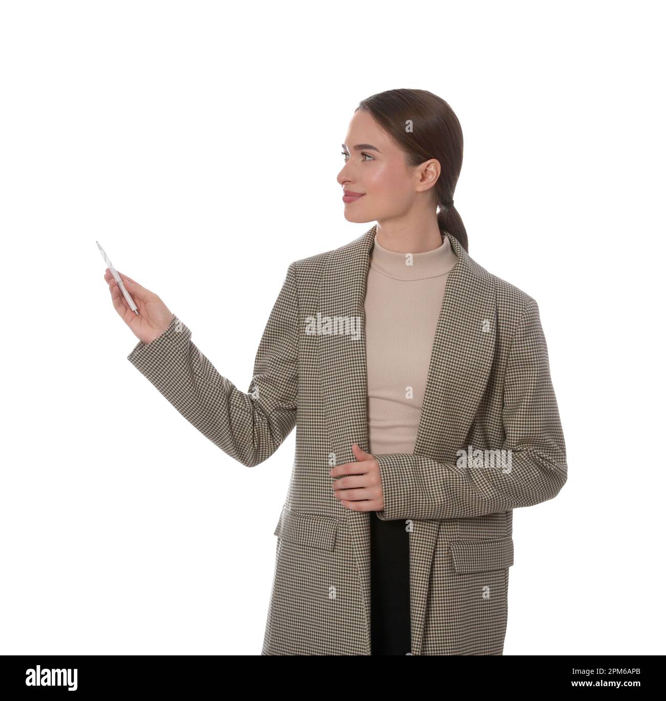 Beautiful woman pointing at something with pen on white background ...