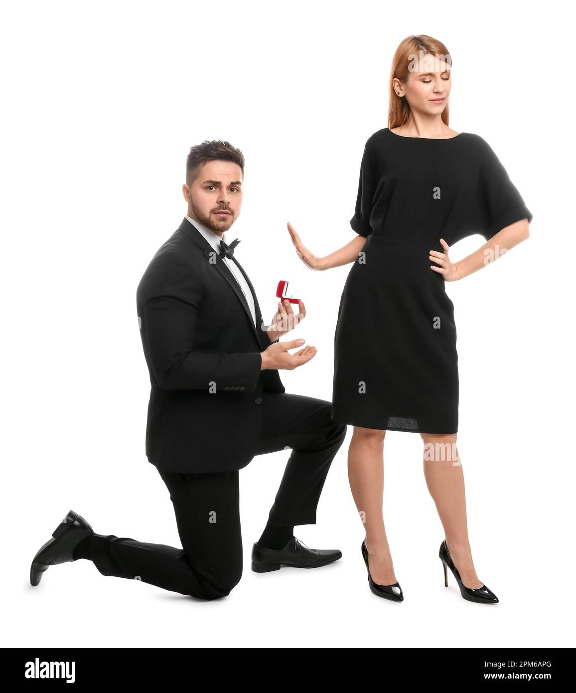 Young woman rejecting engagement ring from boyfriend on white ...