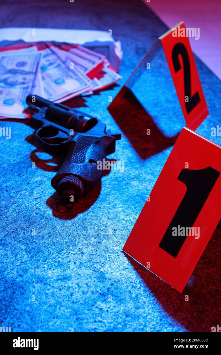 Evidences and crime scene markers on stone background, toned in red and ...