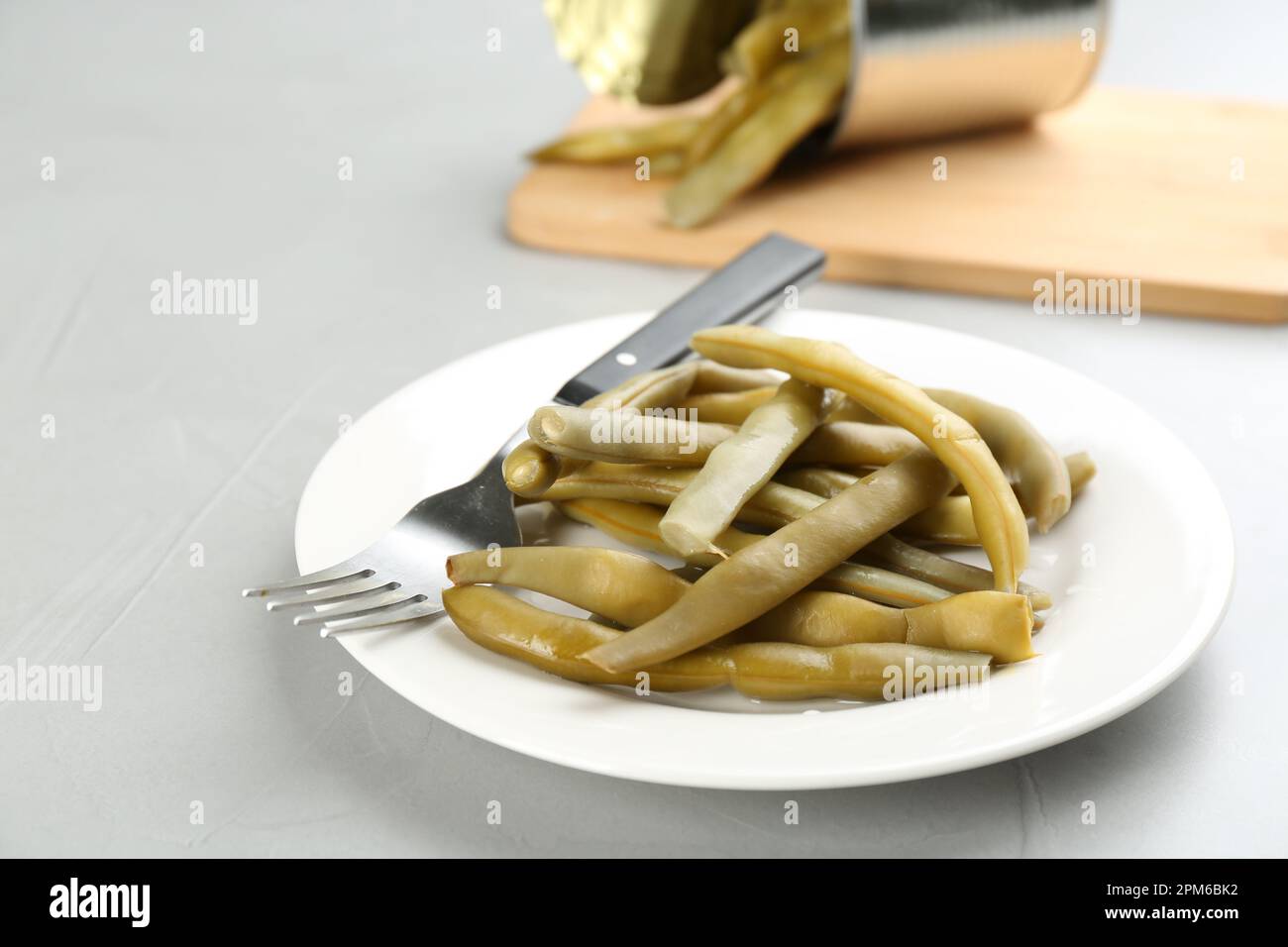 Canned green beans on light grey table Stock Photo - Alamy