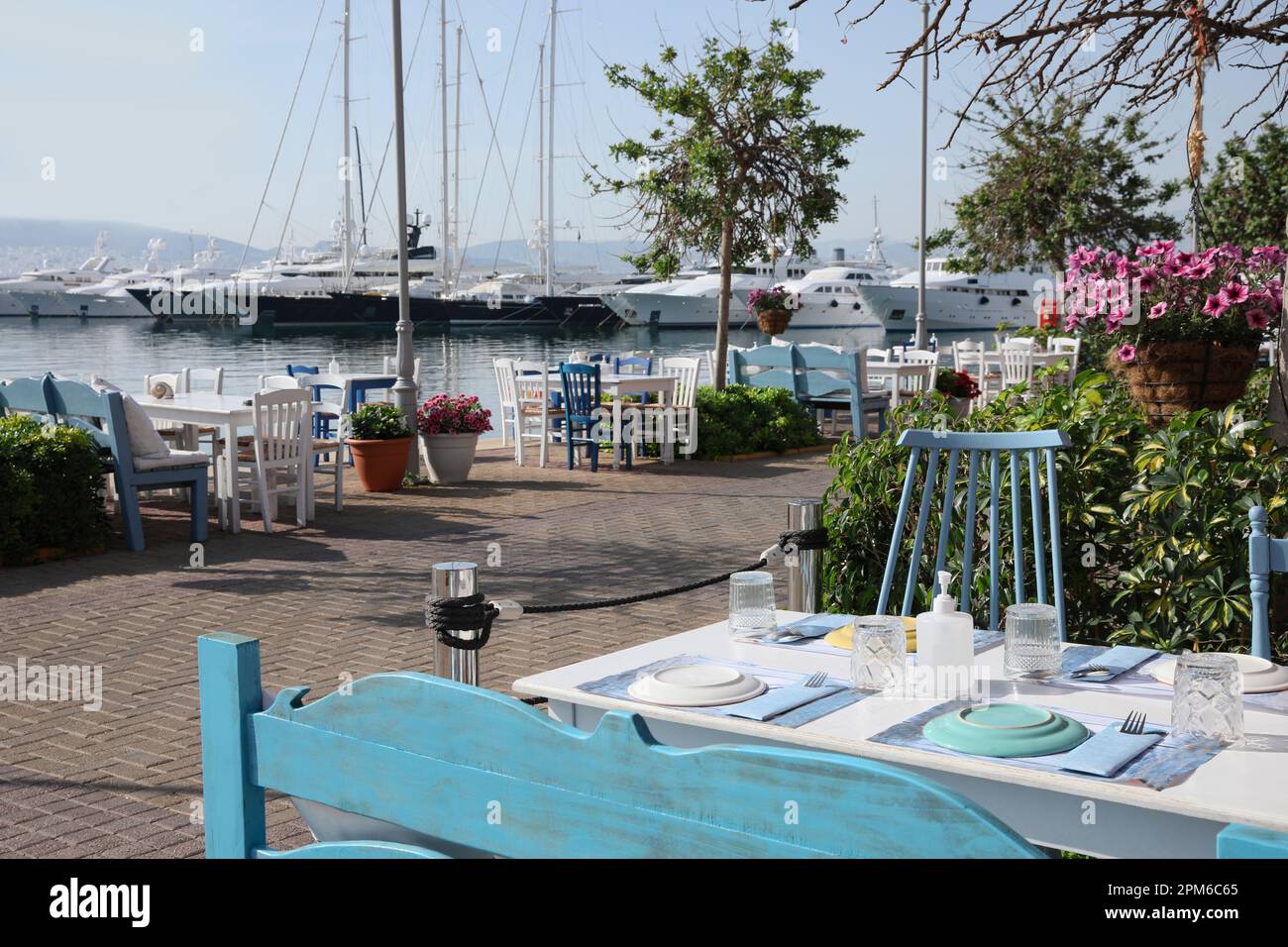 Beautiful view of outdoor cafe with tables near pier Stock Photo - Alamy