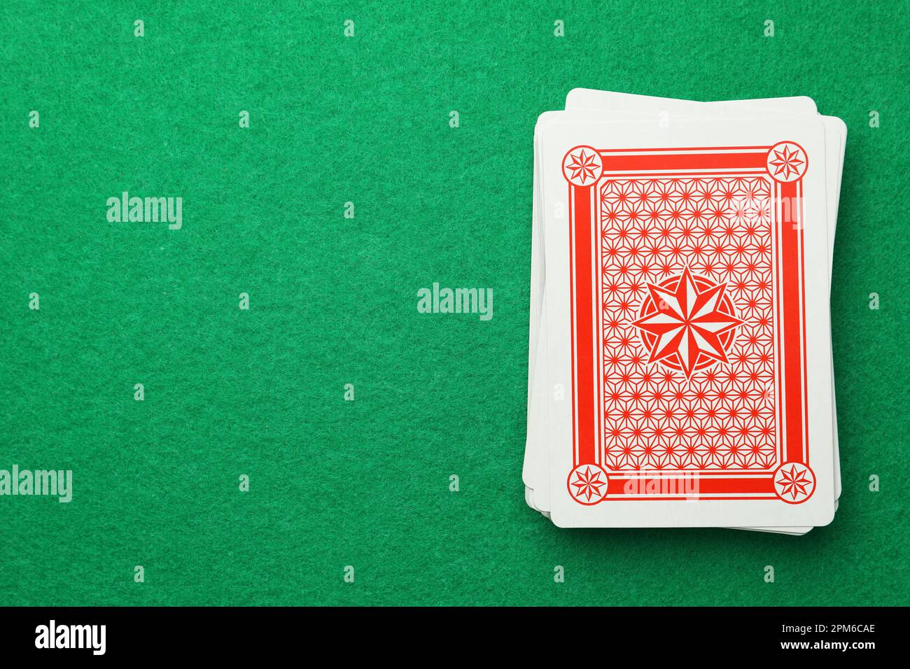 Deck of playing cards on green table, top view. Space for text Stock ...