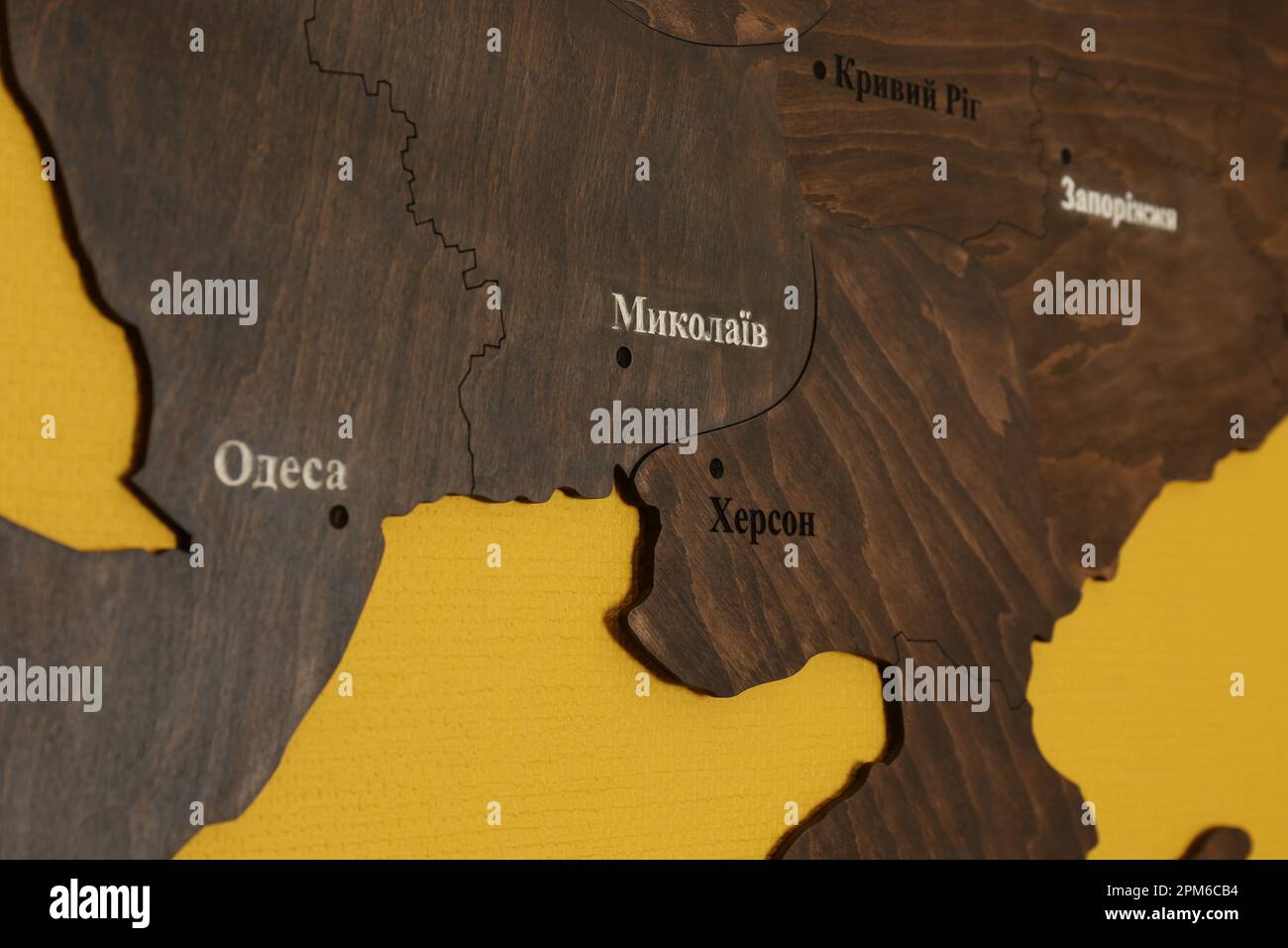 Wooden map of southern Ukraine with city names in Ukrainian on yellow ...