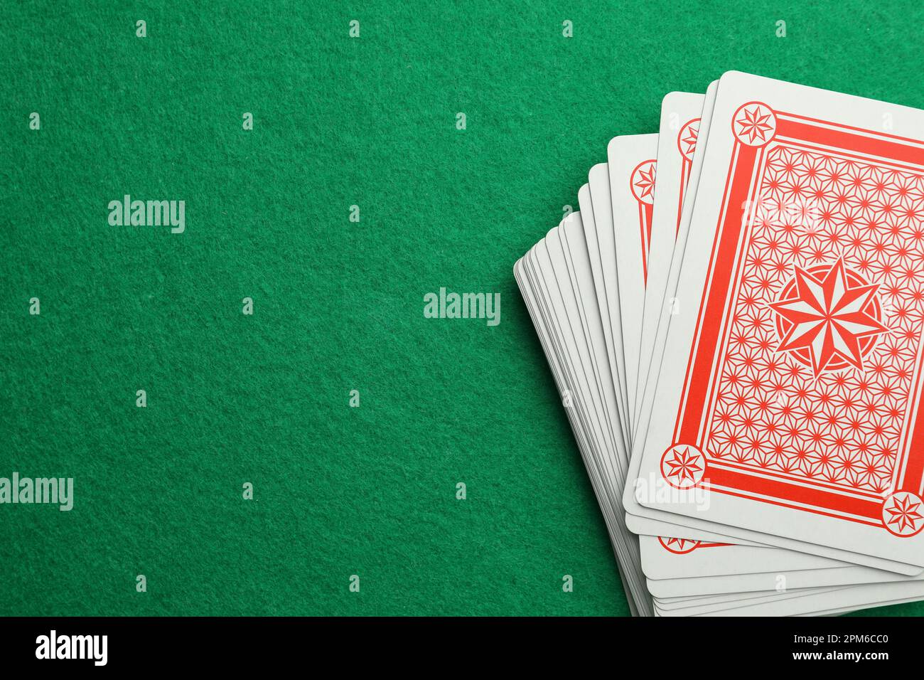 Deck of playing cards on green table, top view. Space for text Stock ...