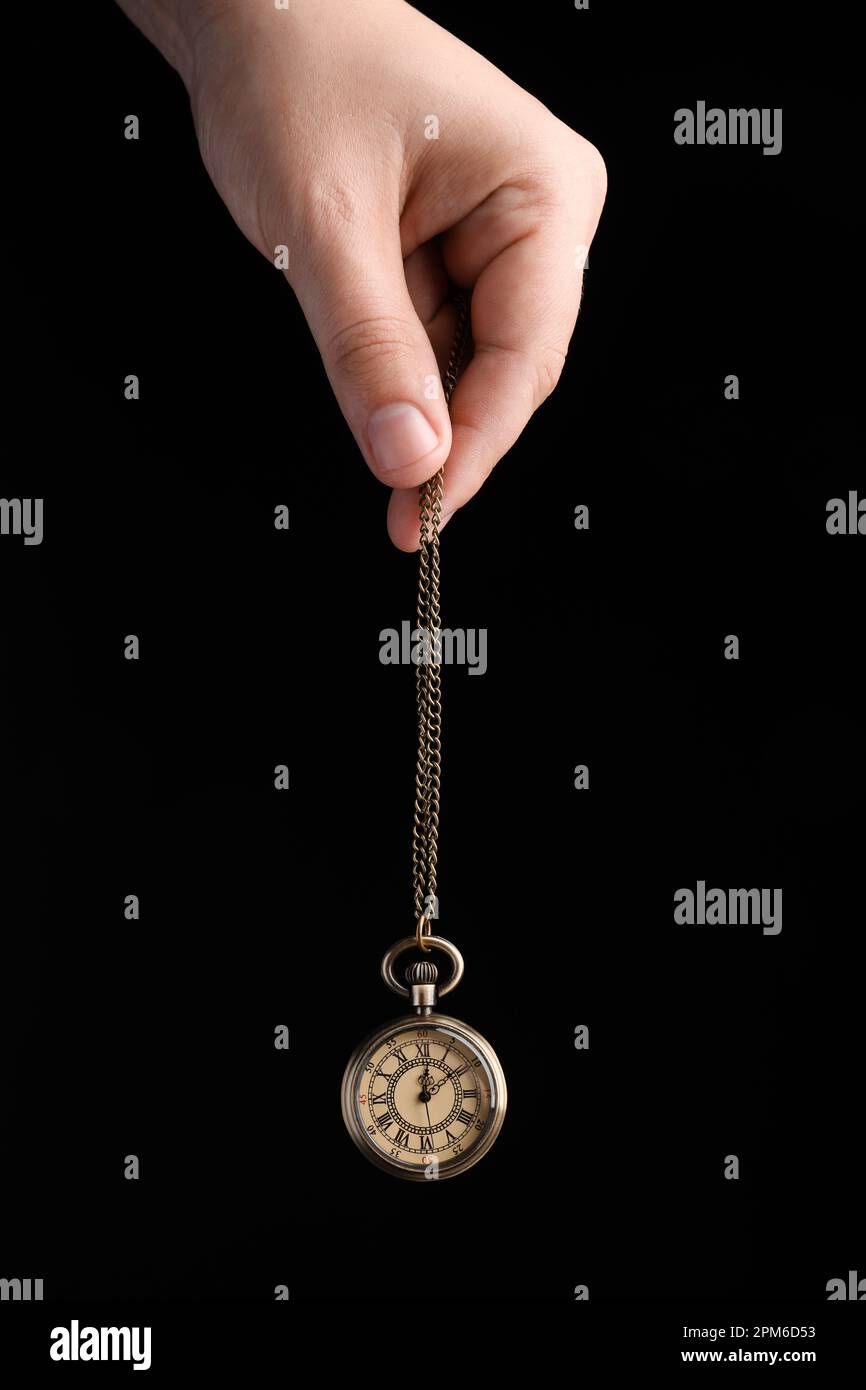 Psychotherapist with pendulum on black background, closeup ...